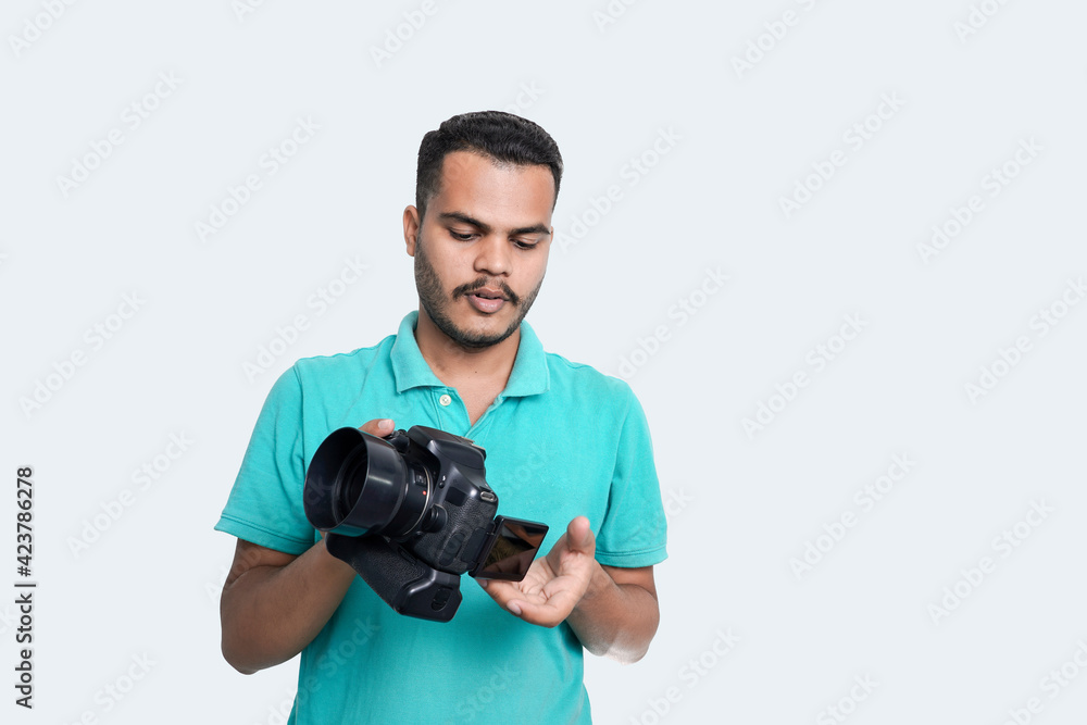 man with a professional DSLR camera, showing thumbs up, checking photos ...