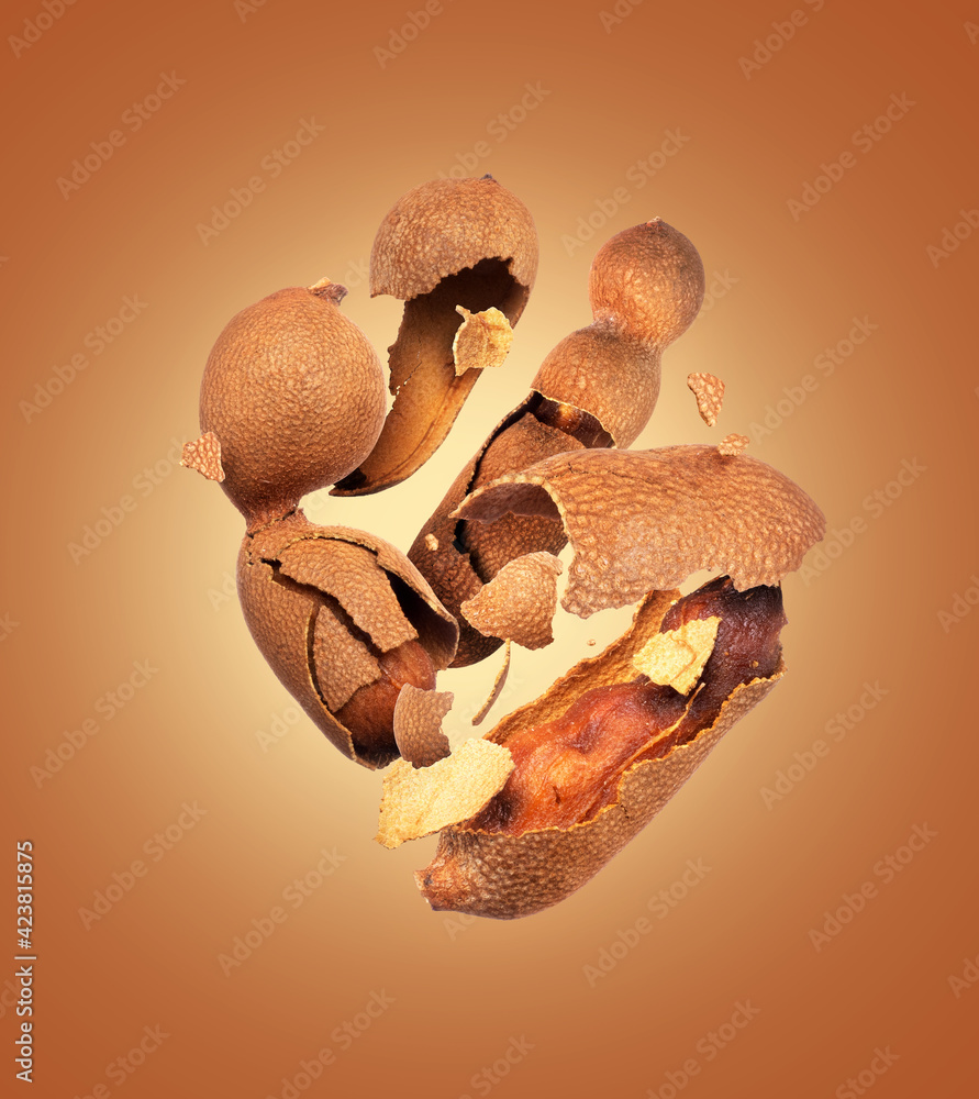 Crushed tamarind in the air close up on a brown background Stock Photo ...
