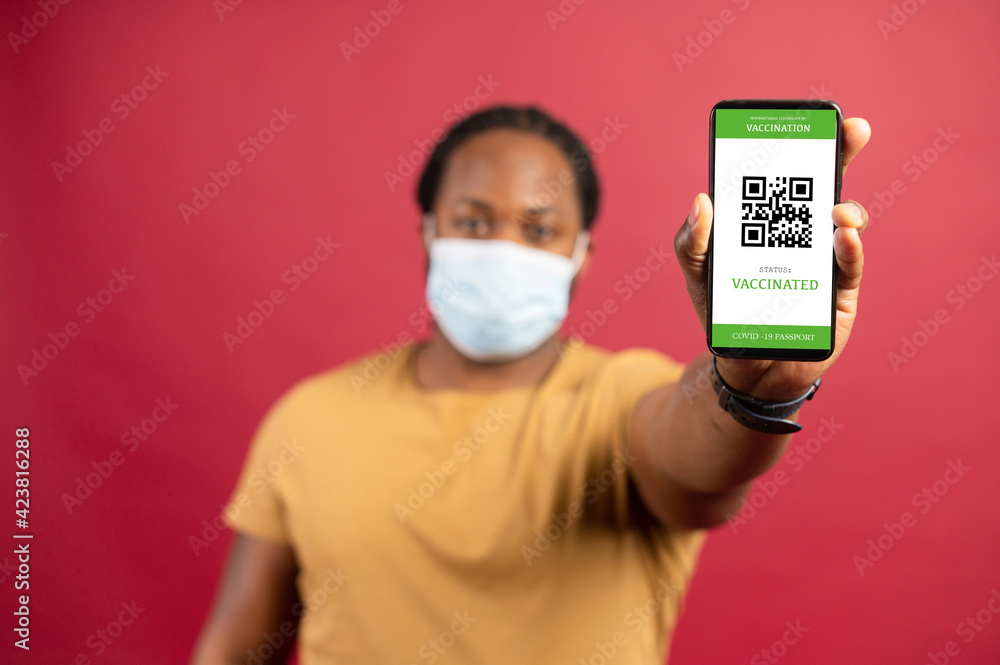 Close-up of qr-code on mobile phone, a blurred African American man in ...