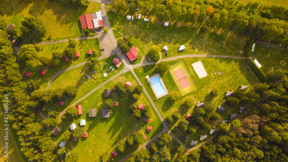 Aerial view of summer camp. Cabins, caravans, swimming pool, tennis ...