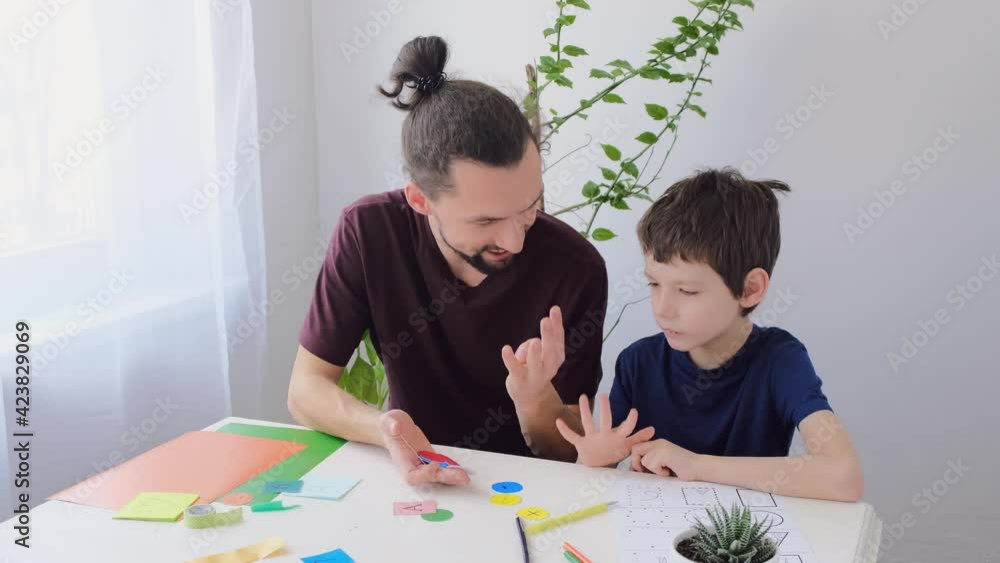 Autistic boy during therapy at home with his father with school ...