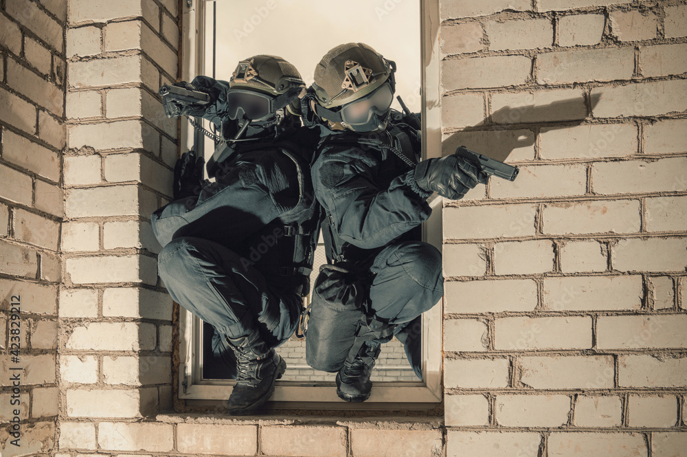Group of special forces fighters storm the building through the window ...