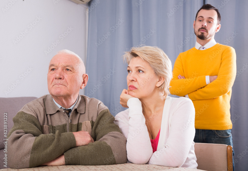 Man seriously talking with mother and grandfather and solving family ...