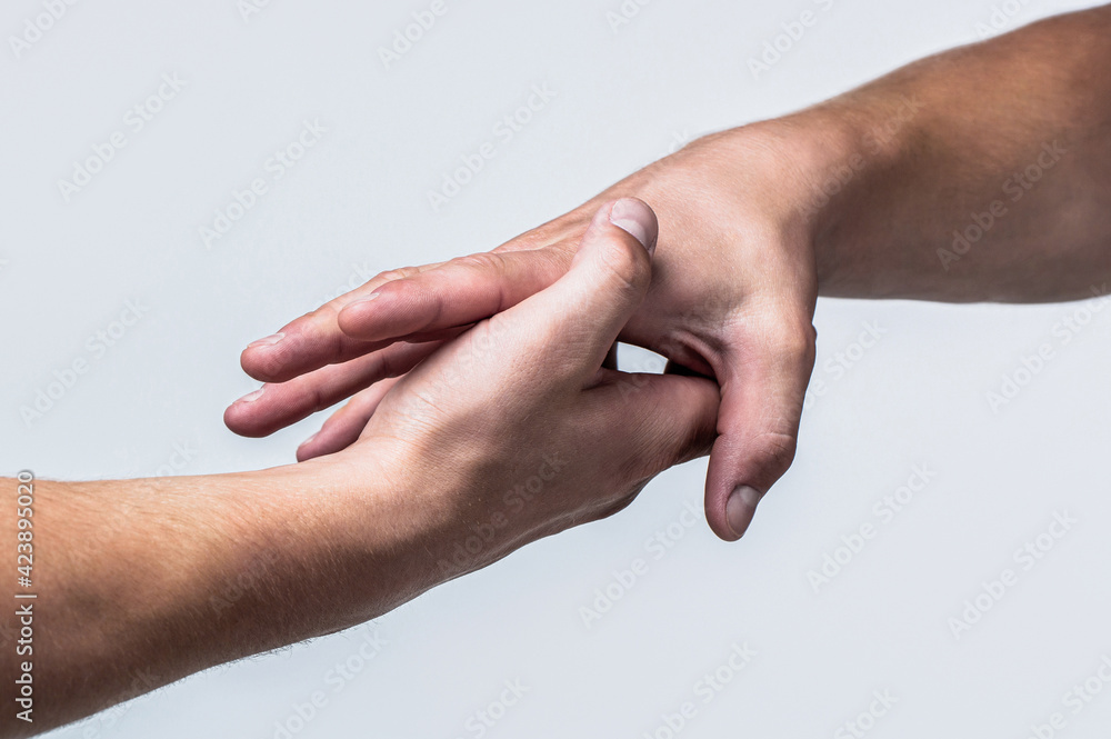 A friendly handshake. Two hands, shaking hands. Two hands, helping arm ...