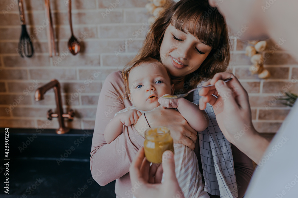 Father feeding kid with child nutrition in spoon. Complementary feeding ...