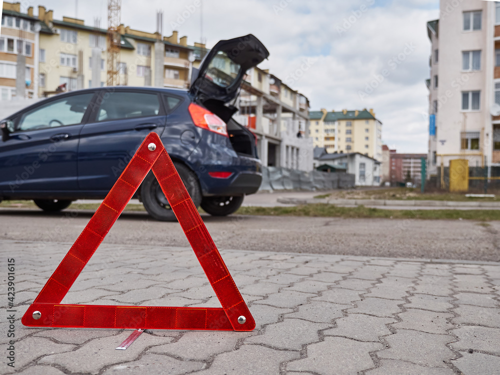 Emergency stop sign on the background of the car with the alarm system ...