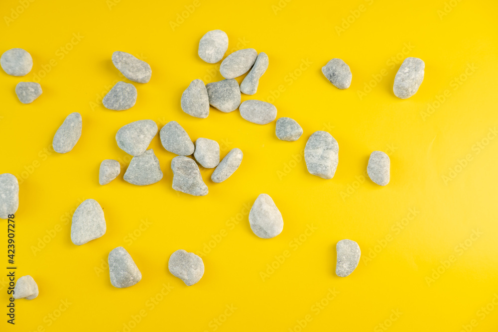 Summer design background with small stones on paper with hard light ...