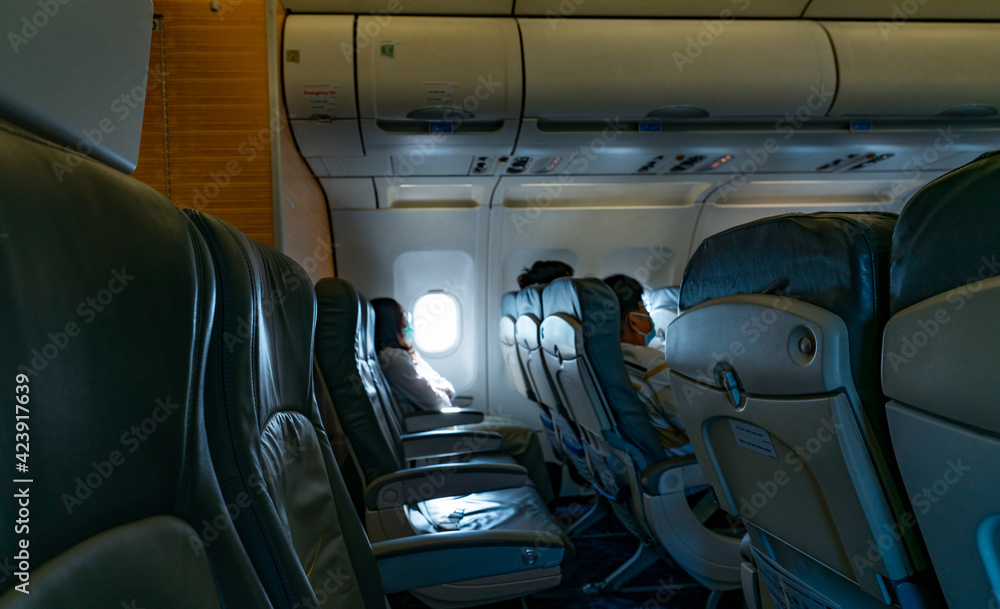 Blur Asian people wear face mask sit on passenger seat of airplane ...