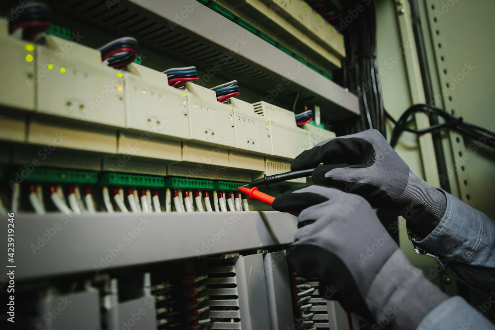 Electrical engineers test electrical installations and wiring on ...