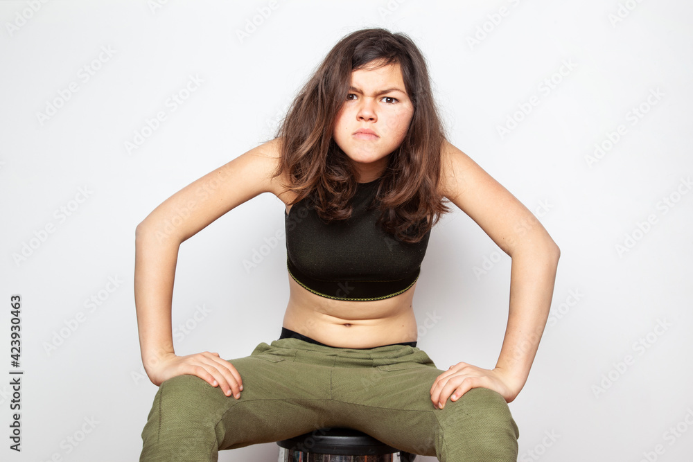 Angry teenage girl standing isolated against white background and ...