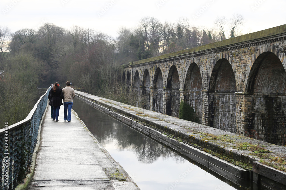 People walking across the Chirk aqueduct beside the Victorian railway ...