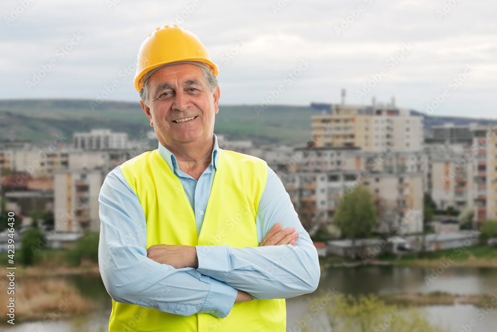 Friendly construction worker with crossed arms town background Stock ...