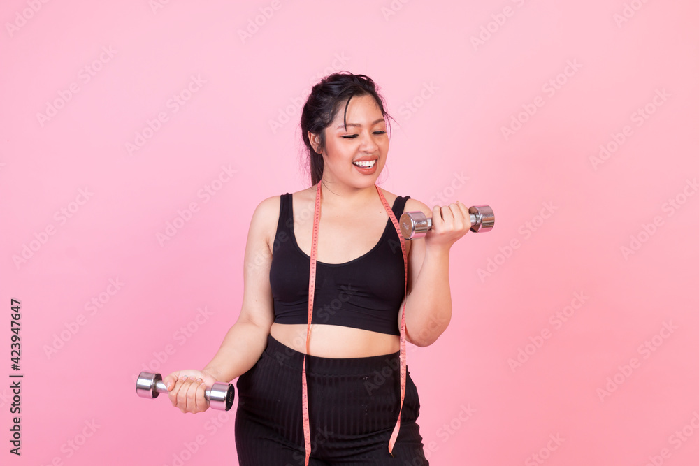 Fat woman with body measures the isolated pink background. Overweight ...