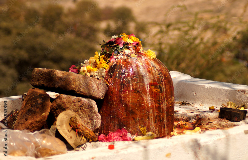 view of stone carved Indian Hindu god Shiva in the shape of Lingam used ...