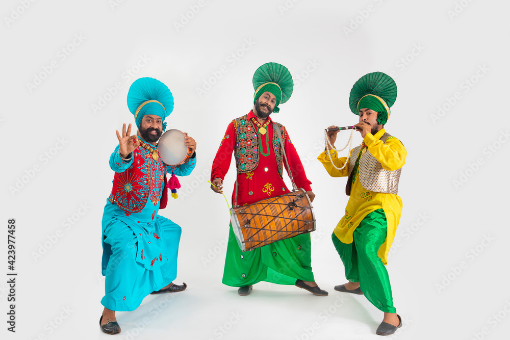 Three Bhangra Dancers playing Dafli,Dhol and Alghoza. Stock Photo ...