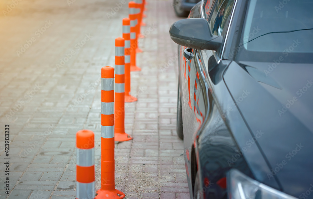 Boundary posts in the parking lot and pedestrian zone. Lot of striped ...