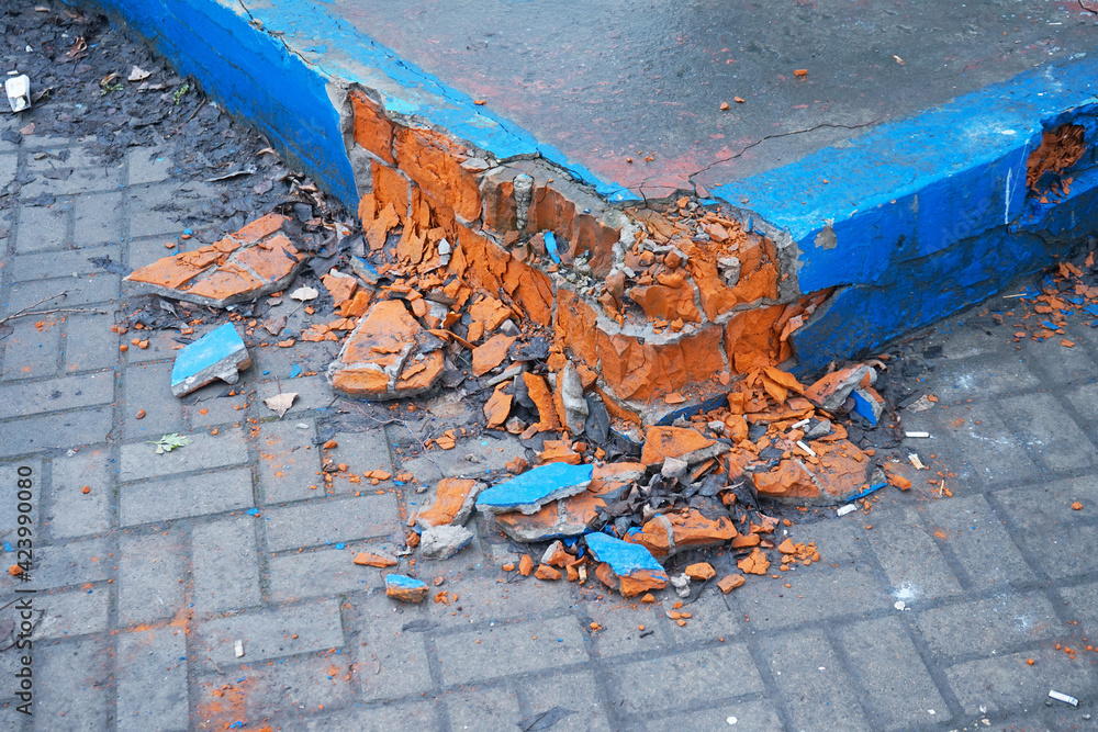 Destroyed brick wall lying on the ground. Old collapsing brick wall ...