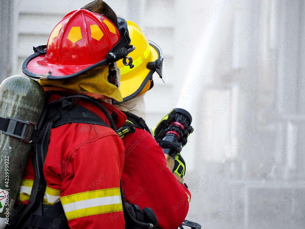 firefighter training., fireman using water and extinguisher to fighting ...