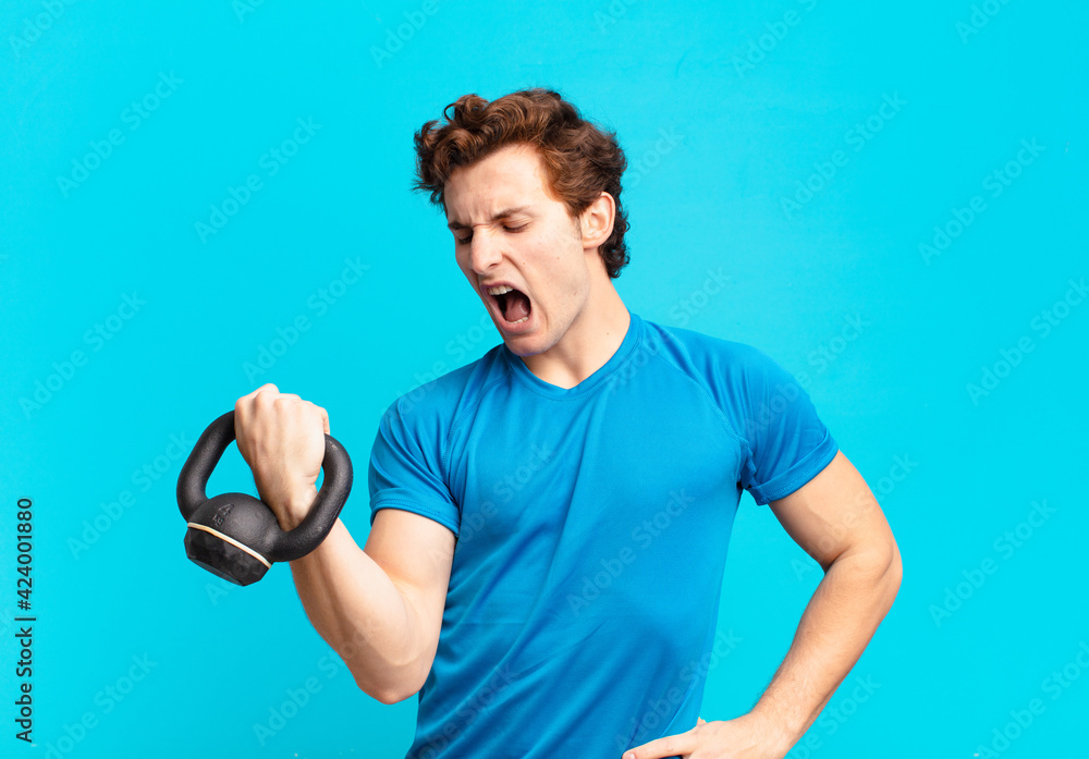 young teenager man young crazy athlete angry expression and lifting a ...