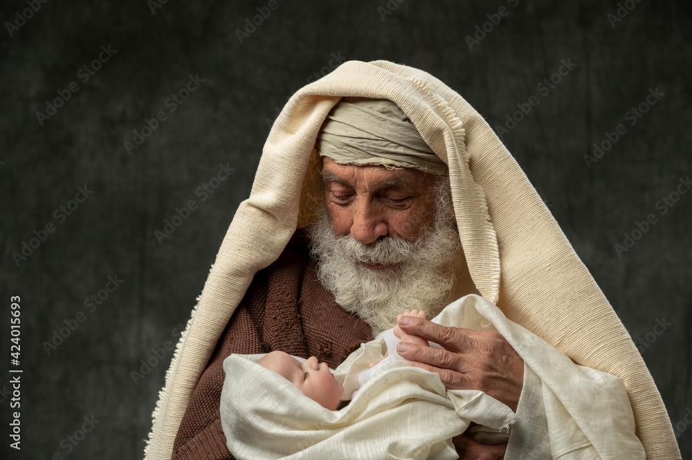 Foto de Simeon holding Baby Jesus in his arms do Stock | Adobe Stock