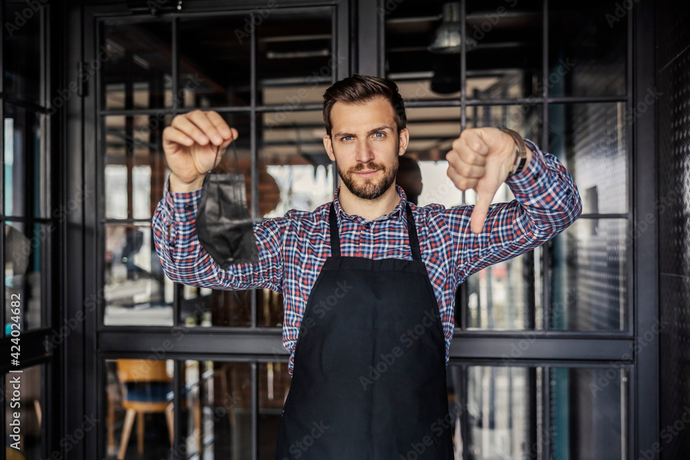 Work in a restaurant during the corona. A portrait of a female waitress ...