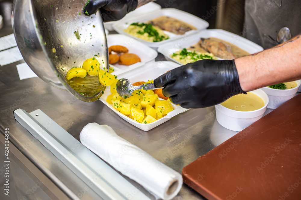 Chef preparing takeaway dish in the restaurant or pub , food delivery ...