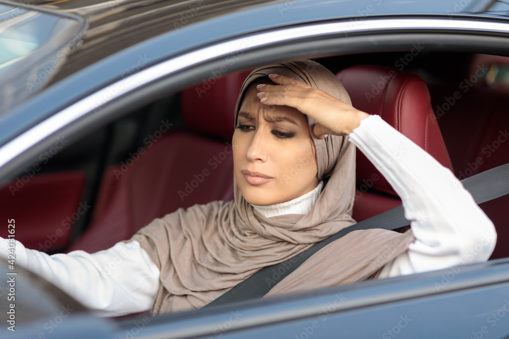 Upset muslim woman driving alone in her new car Stock Photo | Adobe Stock