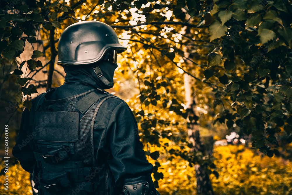 A soldier in special black equipment. Warrior without insignia and ...