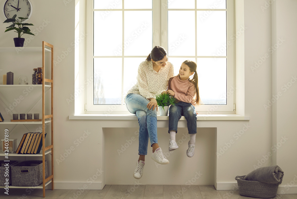 It's so cozy inside, let's stay at home. Happy family backlit by warm ...