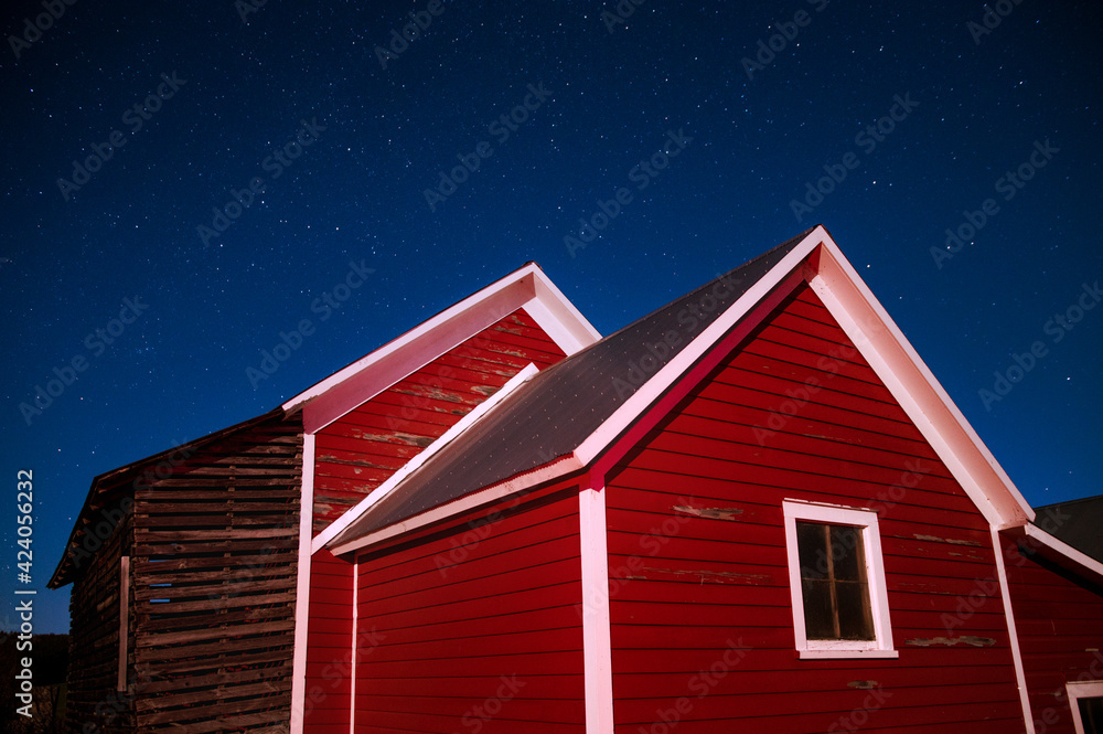 Red barn lit up against the night sky Stock Photo | Adobe Stock