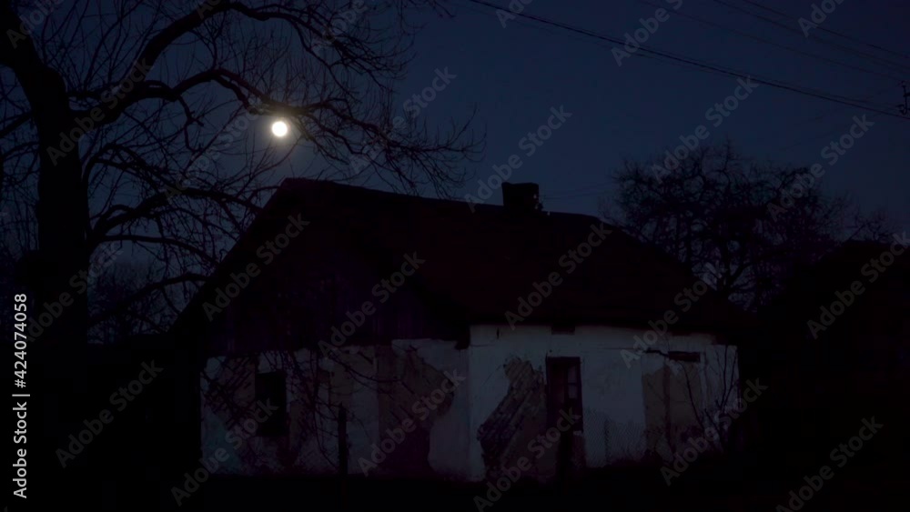 moon over the old house,at night the moon over a scary old house with a ...