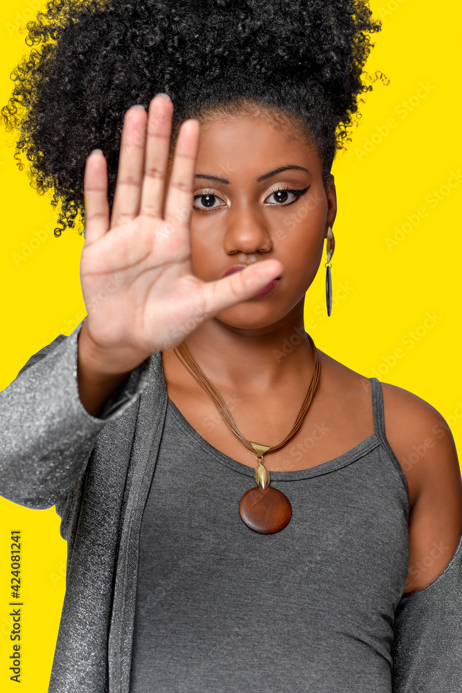 black woman gestures with open hand, denounces aggression, racism ...
