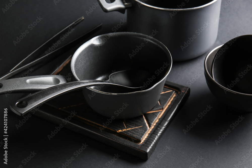 Cooking pots on dark background Stock Photo | Adobe Stock