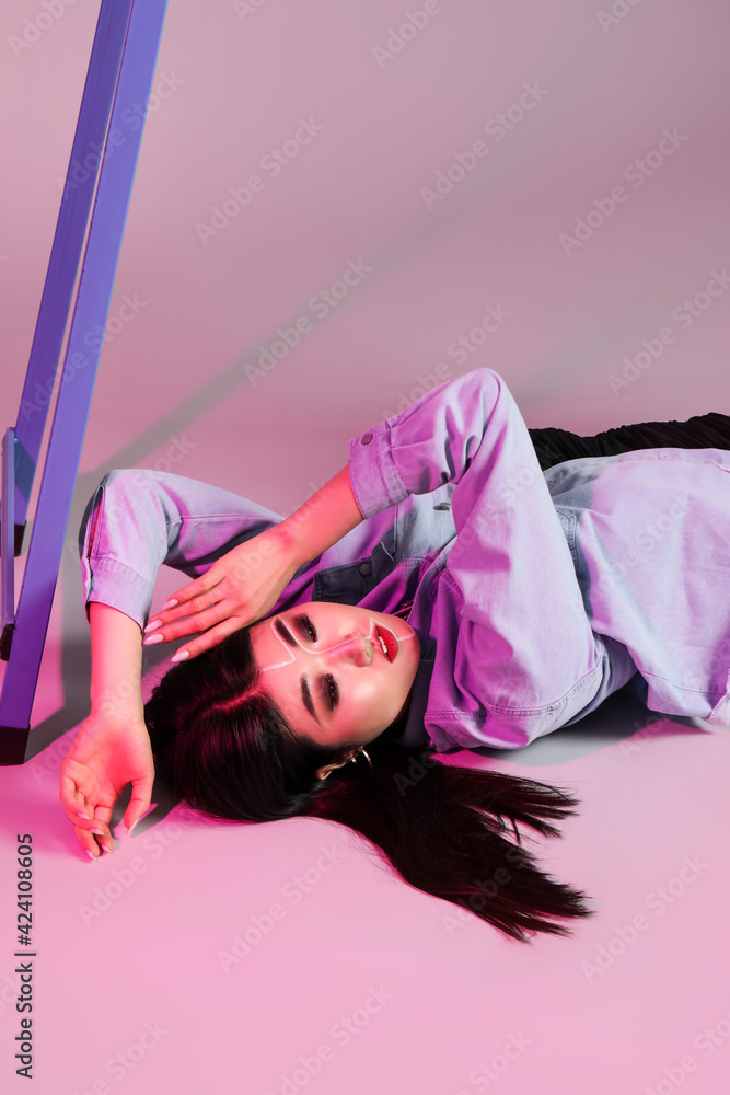 Portrait of stylish Asian woman with ladder on color background Stock ...