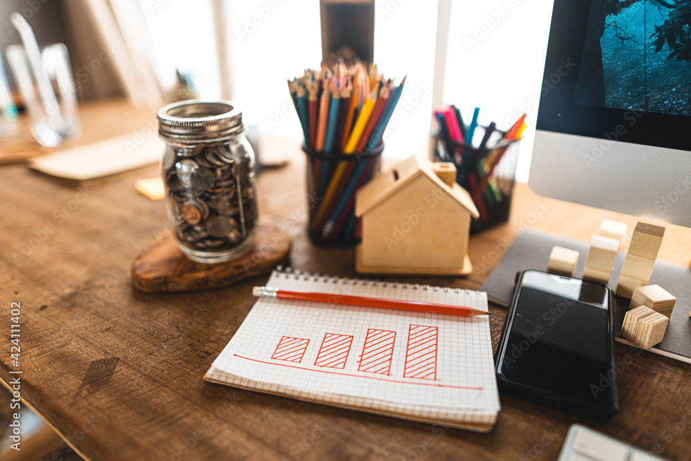 Drawing a graph of growth in a notebook on your desk at home. Stock ...