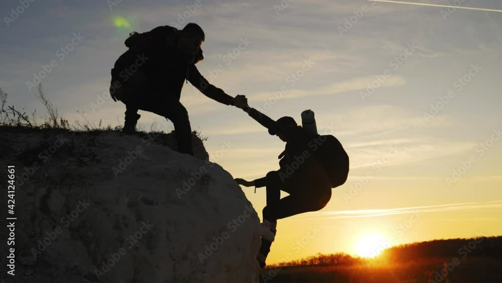 Video „Helping Hand. Man giving hand a teammate to help her to climb ...