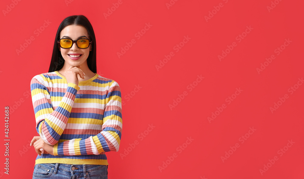 Beautiful young woman wearing stylish sunglasses on color background ...