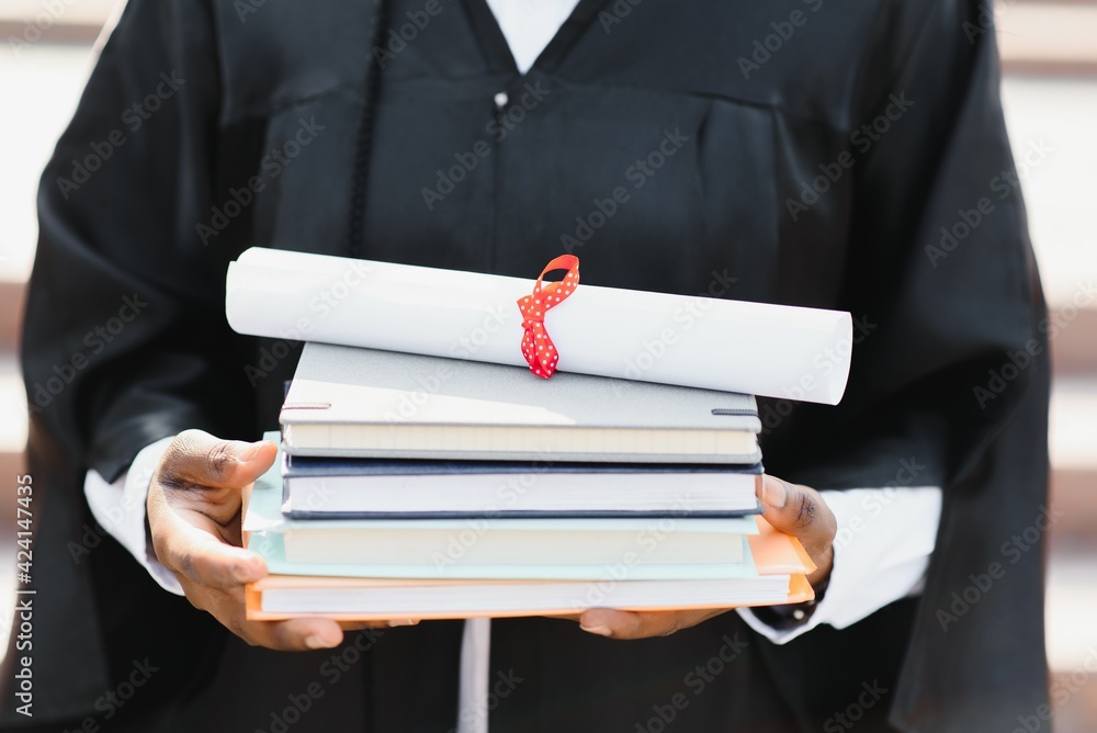graduating student holding her diploma. Close up Stock Photo | Adobe Stock