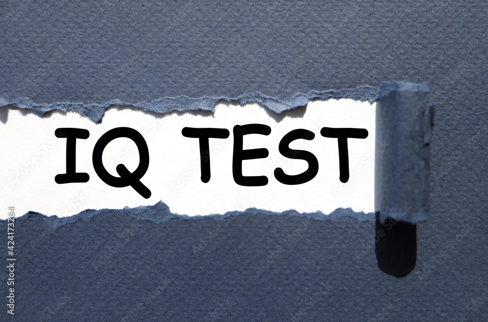 iq test word. text on white paper over torn paper background. Stock ...