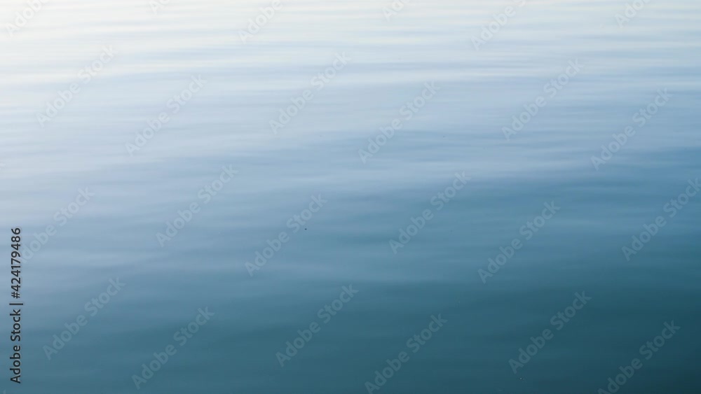Organic and natural blue water background with soft waves and ripples ...