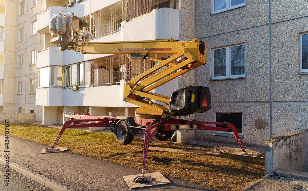 Articulated telescopic boom lift on wheels is ready for facade works ...