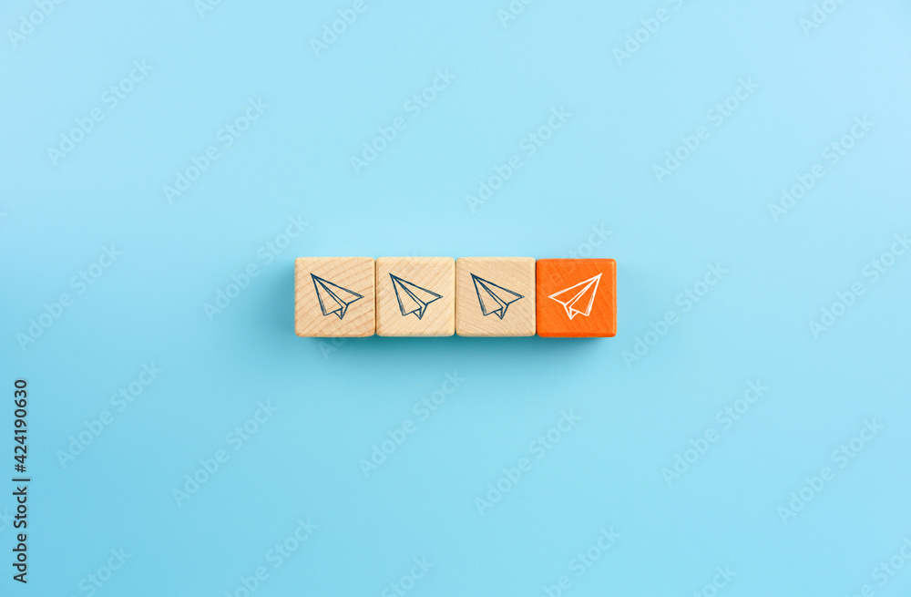Orange wood block with paper plane icons that are different from the ...