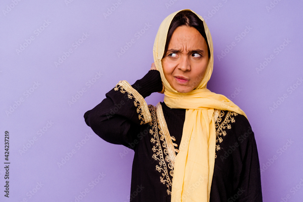 Young arab woman wearing a typical Arabian costume isolated on purple ...
