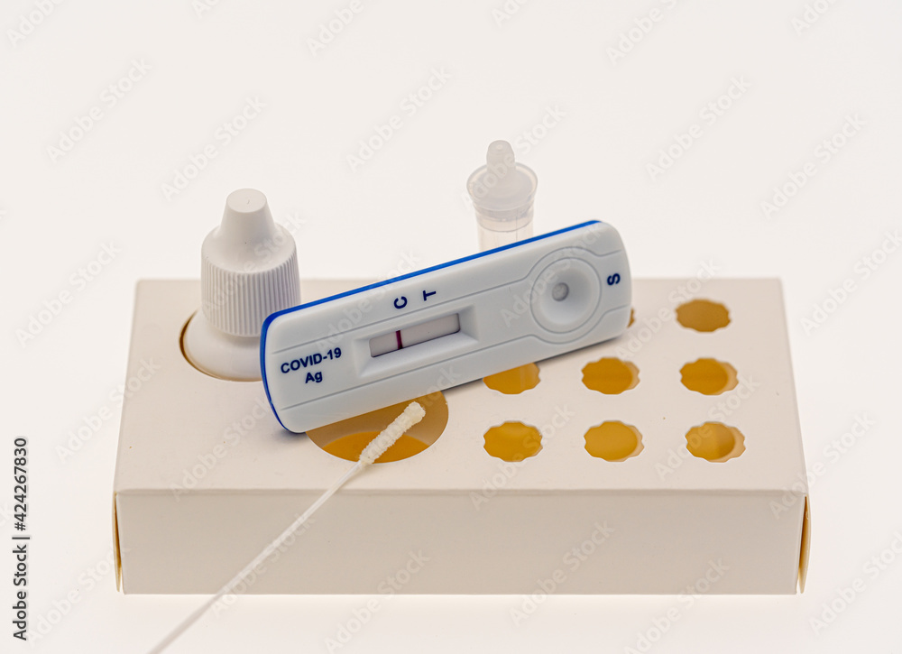 Covid 19 antigen rapid test swab on a white background showing a ...