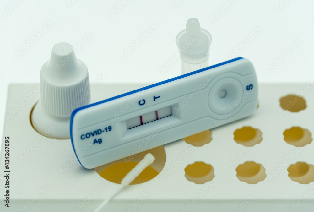 Covid 19 antigen rapid test swab on a white background showing a ...