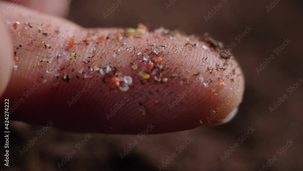 pieces of microplastic on the finger. primary and secondary ...