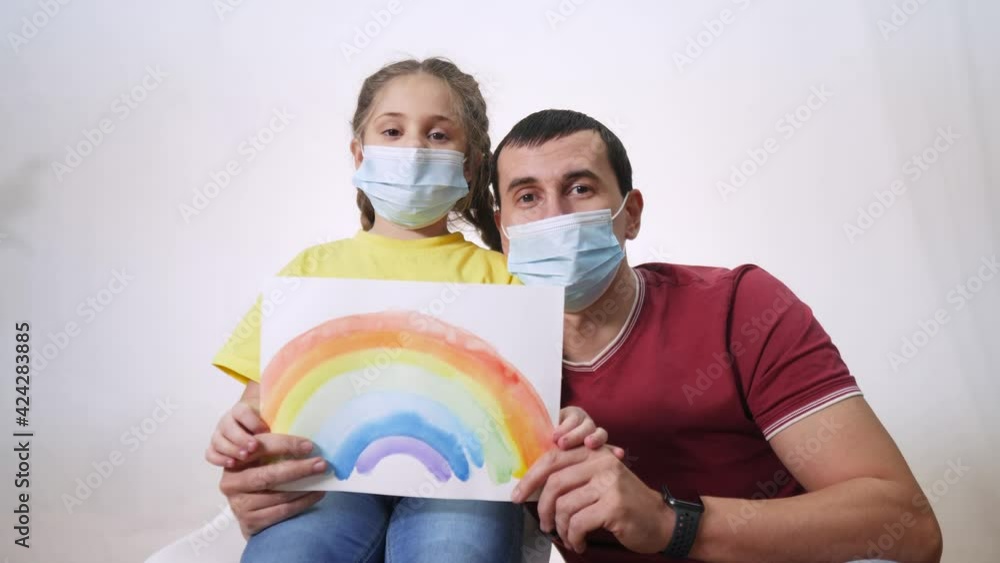 stay home. dad daughter holding a rainbow drawing self-isolation ...