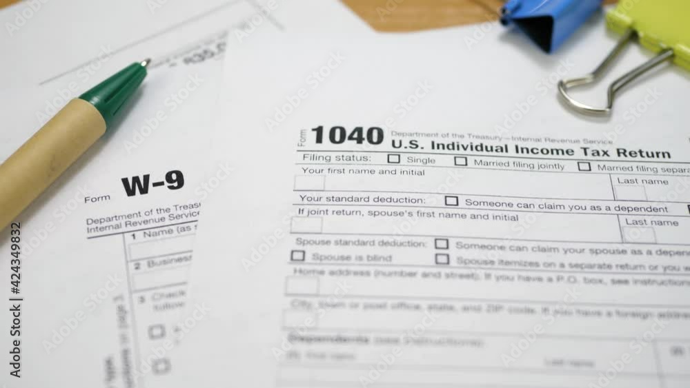 Blank W-9 and Form 1040 U.S. individual income tax return with pen. Tax ...