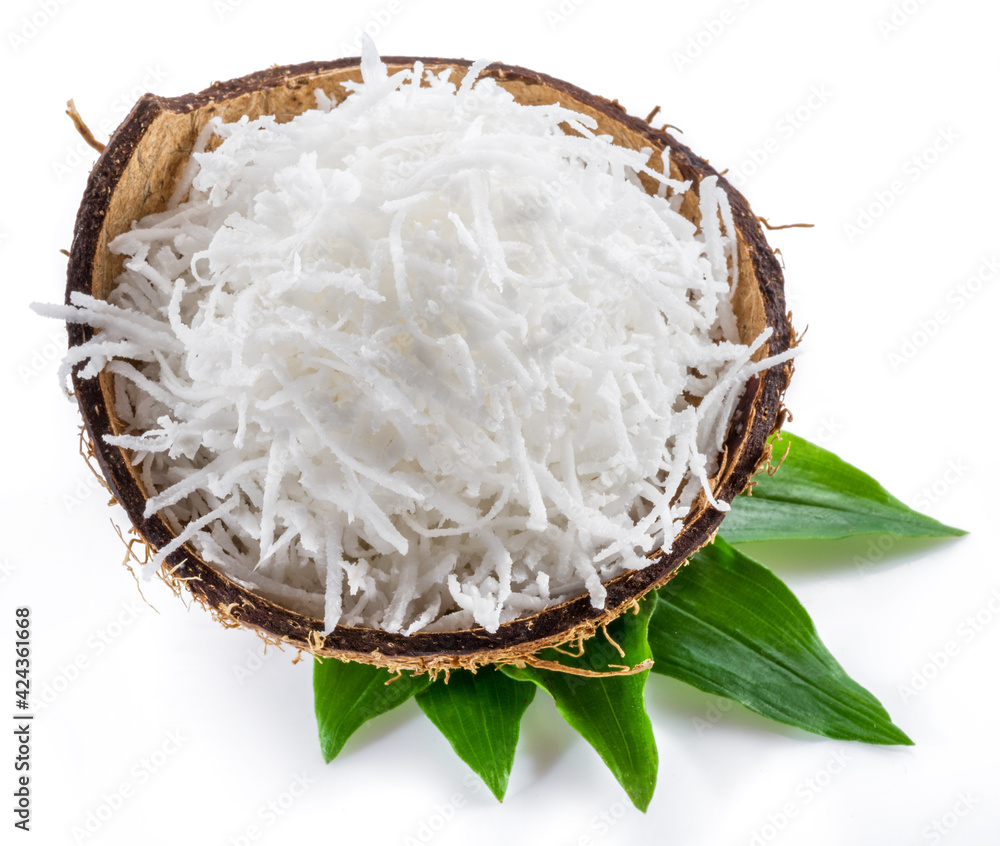 Shredded coconut flakes in the coconut shell isolated on white ...