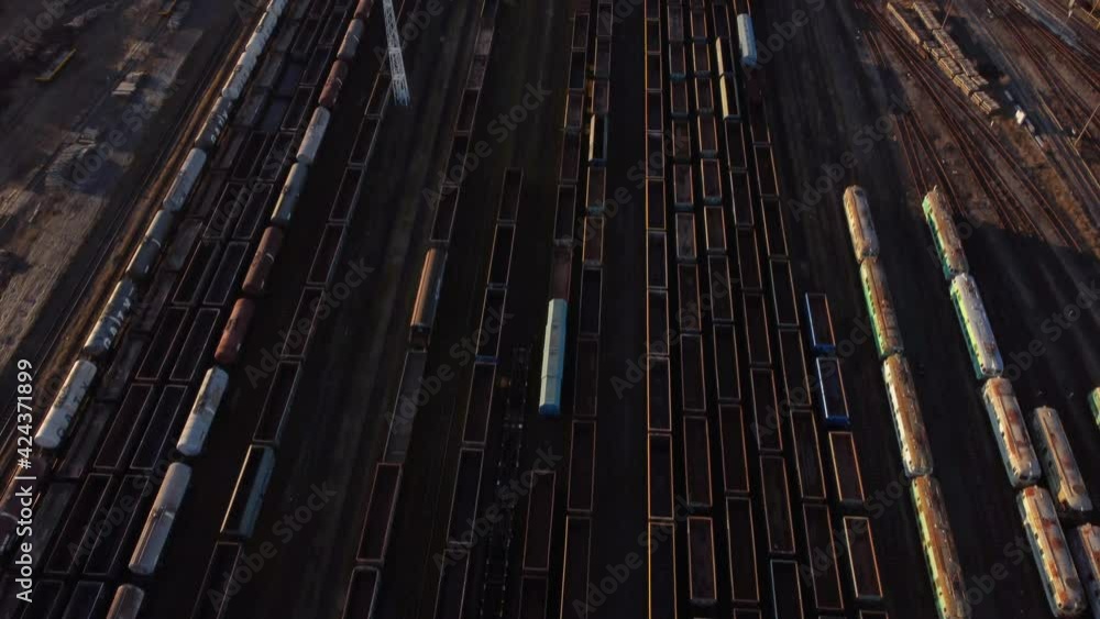 Drone flies over a railway sorting station with trains at sunset ...